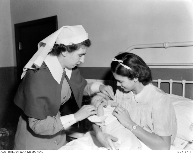 Sister R F Cox of Horsham, VIC, admires the new daughter of Mrs J W ...