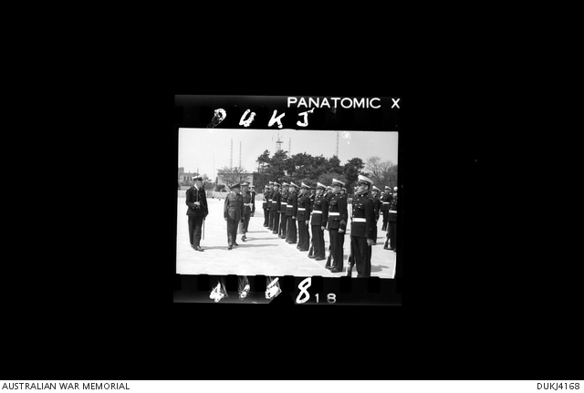 Brigadier R King CBE DSO inspecting a naval detachment at a parade. The ...