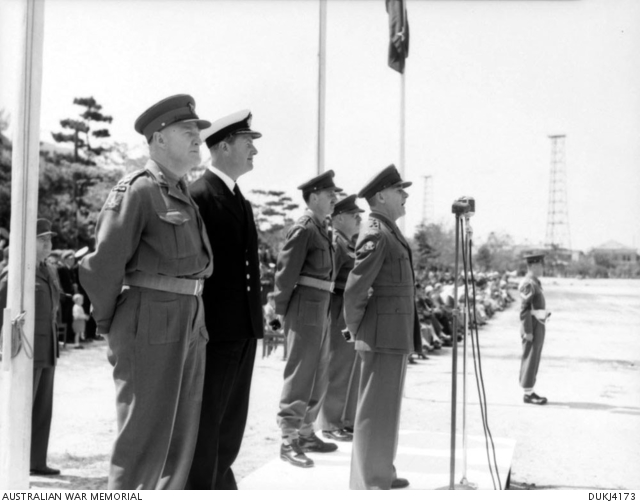 Unidentified army officers and a navy captain on the saluting dais ...