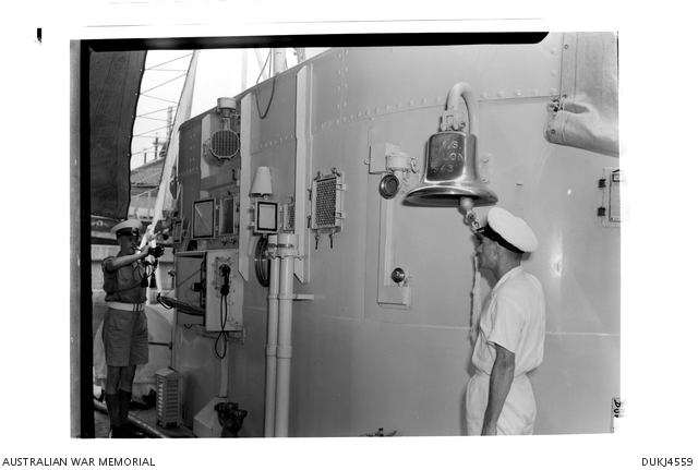 An unidentified petty officer ringing the bell of the Royal Navy ...