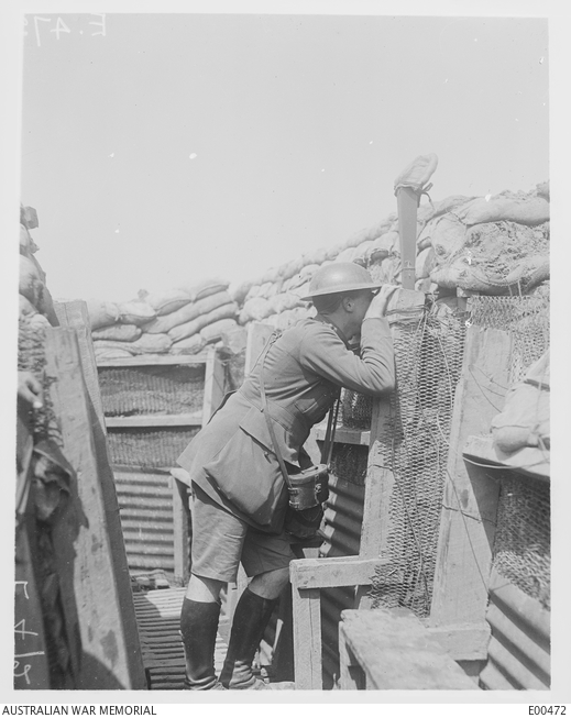An Australian officer in a well constructed trench on Hill 63, viewing ...