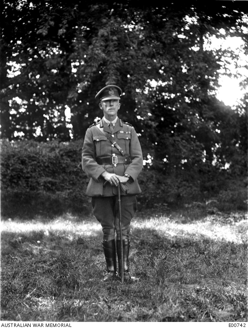 Formal portrait of General Sir J J Talbot Hobbs standing in a shady ...