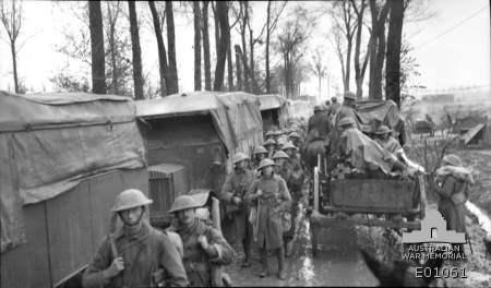 After alighting from lorries, Australian troops march single file ...