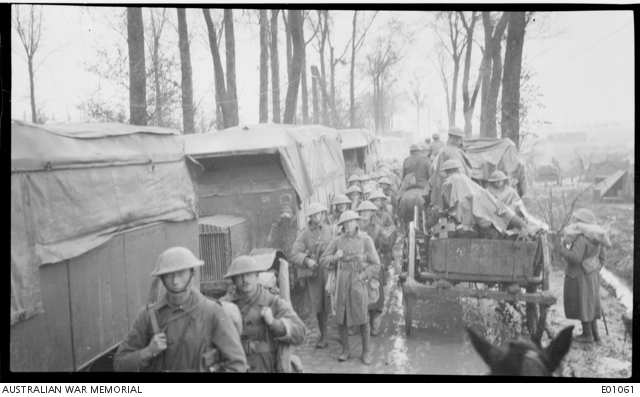 After alighting from lorries, Australian troops march single file ...