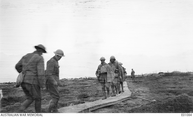 The 26th Battalion returning from the line along the duckboard track ...