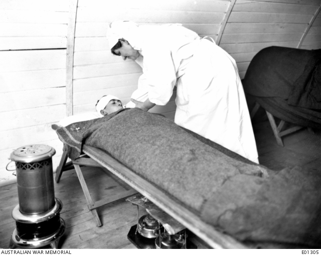 An unidentified nurse preparing a patient in the pre-operation ward of ...
