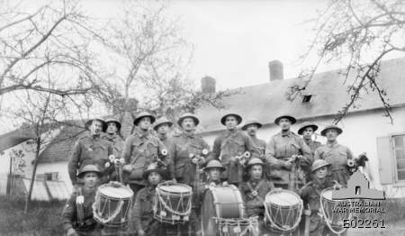 Outdoor group portrait of the band of the 52nd Battalion. The four men ...