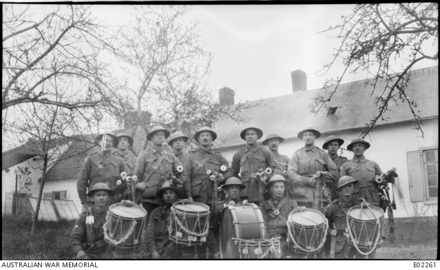 Outdoor group portrait of the band of the 52nd Battalion. The four men ...