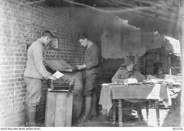 The staff, 6167 Private (Pte) E. E. Webster, printer (left), and 4479 ...