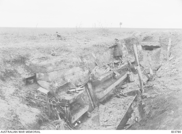 An unidentified Australian soldier stands on a concrete fire step in a ...