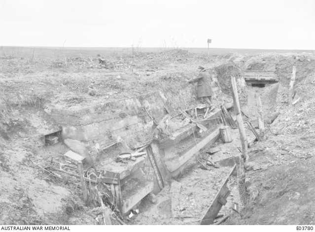 An unidentified Australian soldier stands on a concrete fire step in a ...