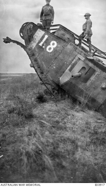 Two unidentified American soldiers standing on top of a ditched and ...