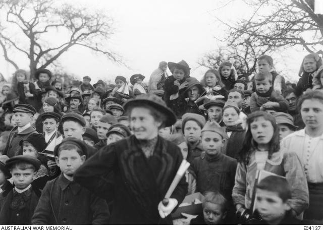 A group of Belgian children, some holding toys, at a fete held by the ...