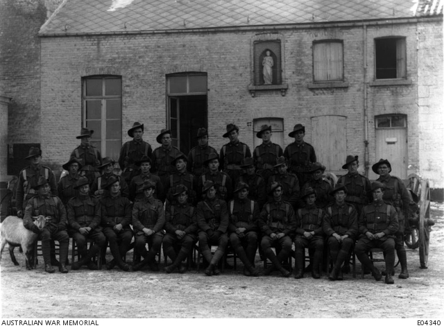 An outdoors group portrait of a draft of men of the 22nd Battalion, all ...
