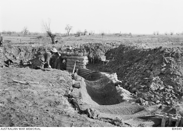 Two unidentified Australian soldiers talking to one another in a trench ...