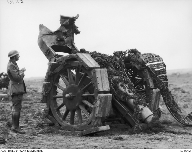 An unidentified officer, probably British, looking at a 6 inch Howitzer ...