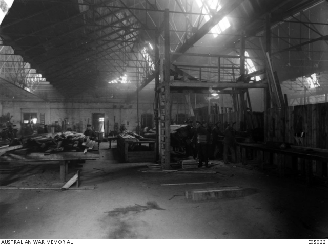 Unidentified students and German prisoners in the wood-working machine ...
