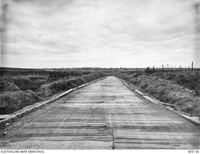 A wooden plank road leading to the village of Bellicourt on the distant ...
