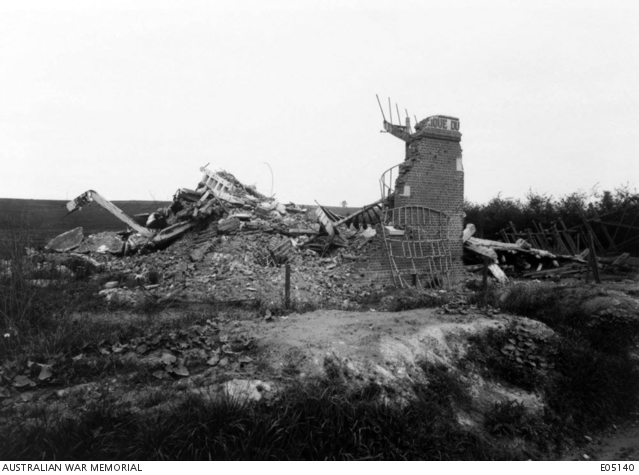 The ruins of a brick and reinforced concrete building showing the ...