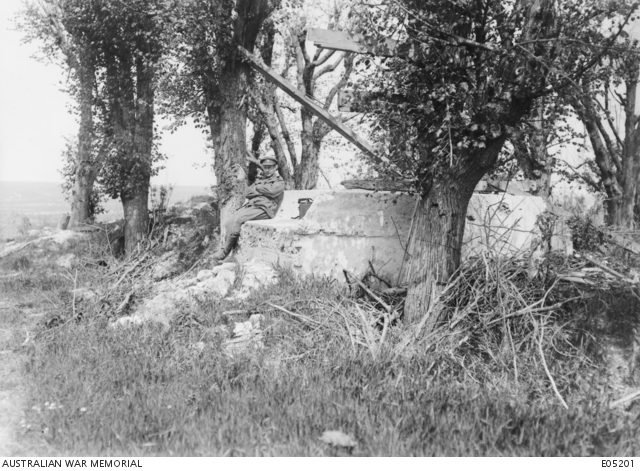 An unidentified British soldier sitting on a concrete observation post ...