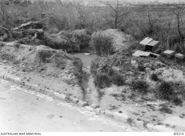 A ditch cut near a roadside to redirect surplus water from drains into ...