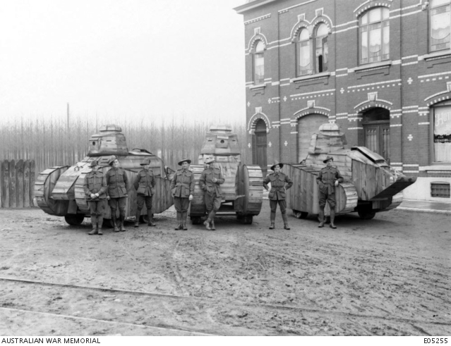Seven unidentified Australian soldiers gathered around three German ...