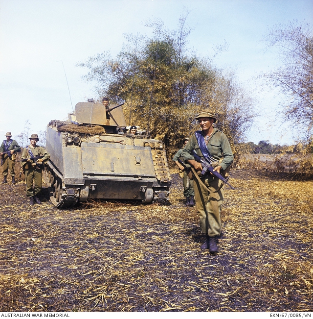 Walking beside an M113 armoured personnel carrier (APC) from 3rd ...