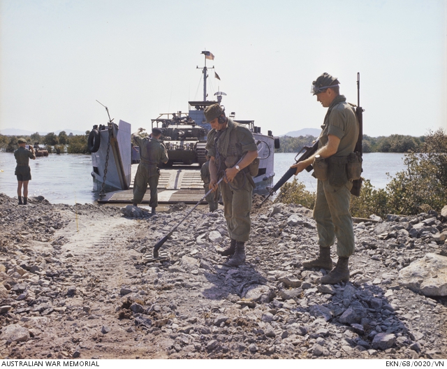 Engineers use a detector to check the rocky beach for land mines as the ...
