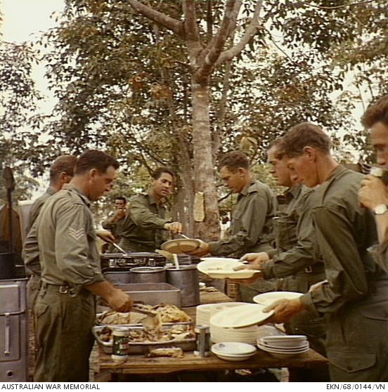 South Vietnam. December 1968. Soldiers lined up in the outdoors to fill ...