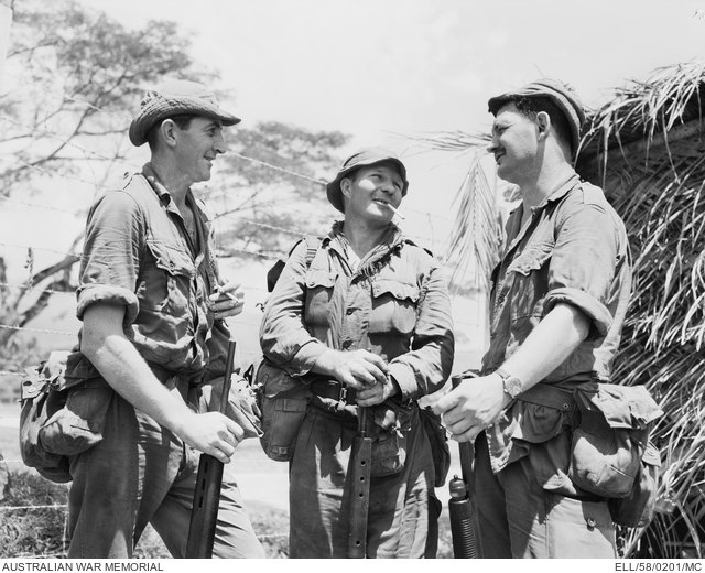 Informal portrait of three Australian soldiers from 6 Platoon, B ...