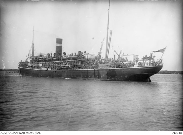 Troops aboard an Australian transport crowd the decks as the ship ...