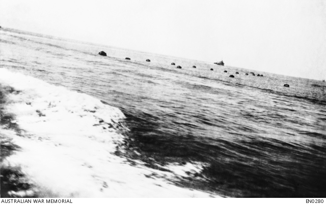 The destroyer HMAS Huon enters the boom defence system in the harbour ...
