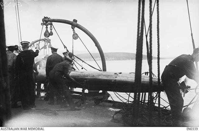 Several unidentified gunners take a torpedo on board HMAS Sydney during ...