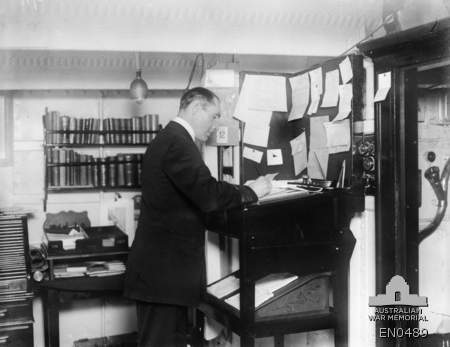 Captain Oliver Backhouse CB, RN, at work in his cabin on board HMAS ...