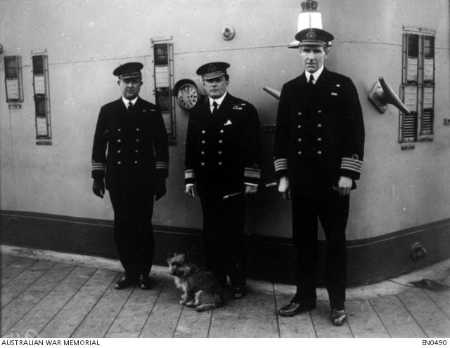Group portrait of three Royal Navy officers on board HMAS Australia ...