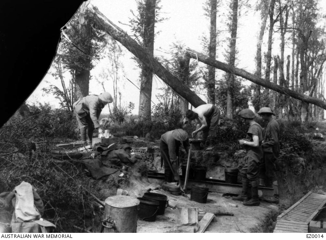 Unidentified Australian cooks preparing to cook a meal in a wood behind ...