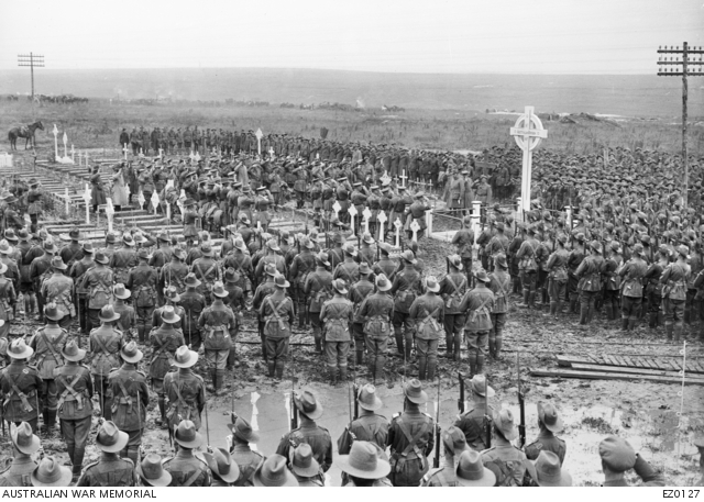 Australian officers salute and soldiers present arms as the memorial to ...