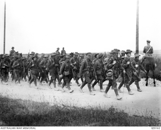 Australian soldiers of the 2nd Division marching along a road to a new ...