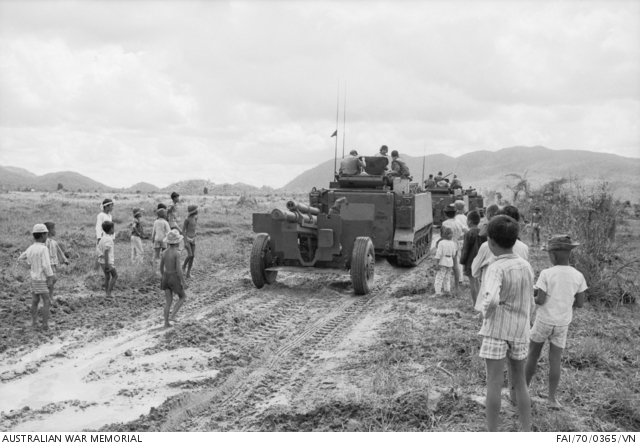Phuoc Tuy Province, South Vietnam. June 1970. Vietnamese children watch ...