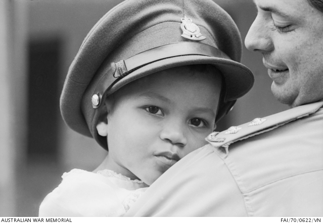 This little girl looks out from under the big Australian Army Ordnance ...