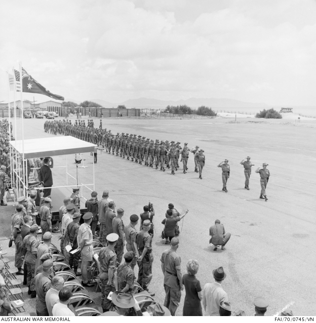Official guests and spectators stand as the members and ex-members of ...