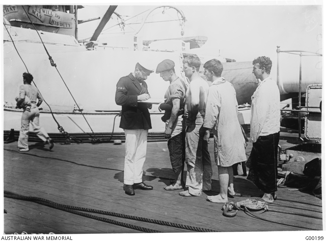 Survivors in borrowed clothes from the battleship HMS Triumph, on board ...