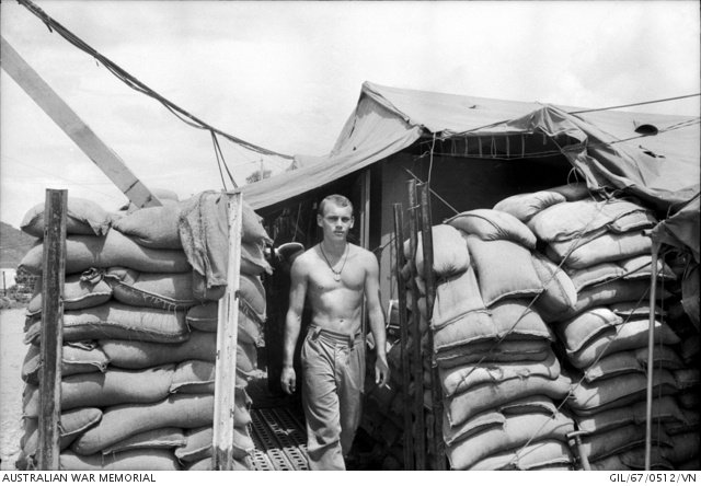 Vietnam. 1967-06. Signalman W. Paul Goldstone, bare-chested and smoking ...