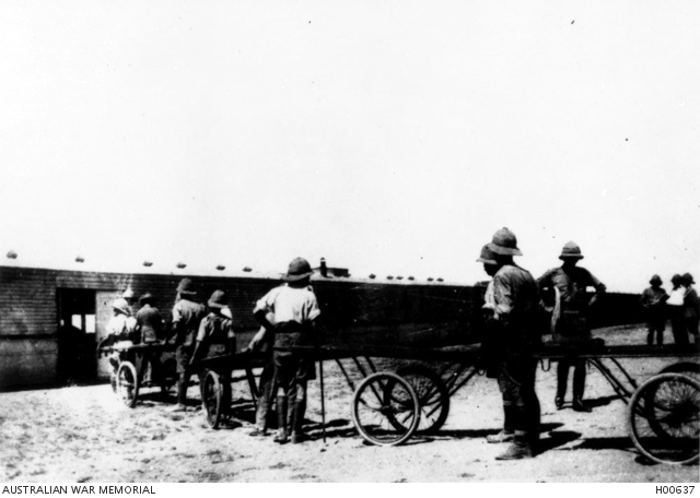Wounded soldiers being transferred on wheeled stretchers at 69th ...
