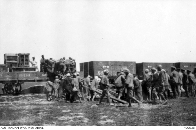 Local men unloading equipment from a train for the 69th General ...