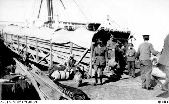 Soldiers disembarking via the covered gangway from HMHS Assay ...