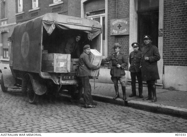 German prisoners unloading goods from trucks at a Red Cross depot ...