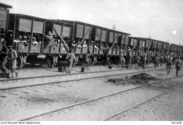 SINAI, 1917. TROOPS ON RAILWAY TRUCKS RECEIVE YMCA REFRESHMENTS AFTER ...
