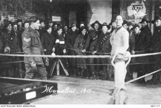 Australian 1st Division soldiers at the YMCA Boxing Arena look on as ...