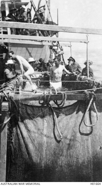 AT SEA. 1919. SOLDIERS BATHING IN AN IMPROVISED POOL ON BOARD HMAT ...